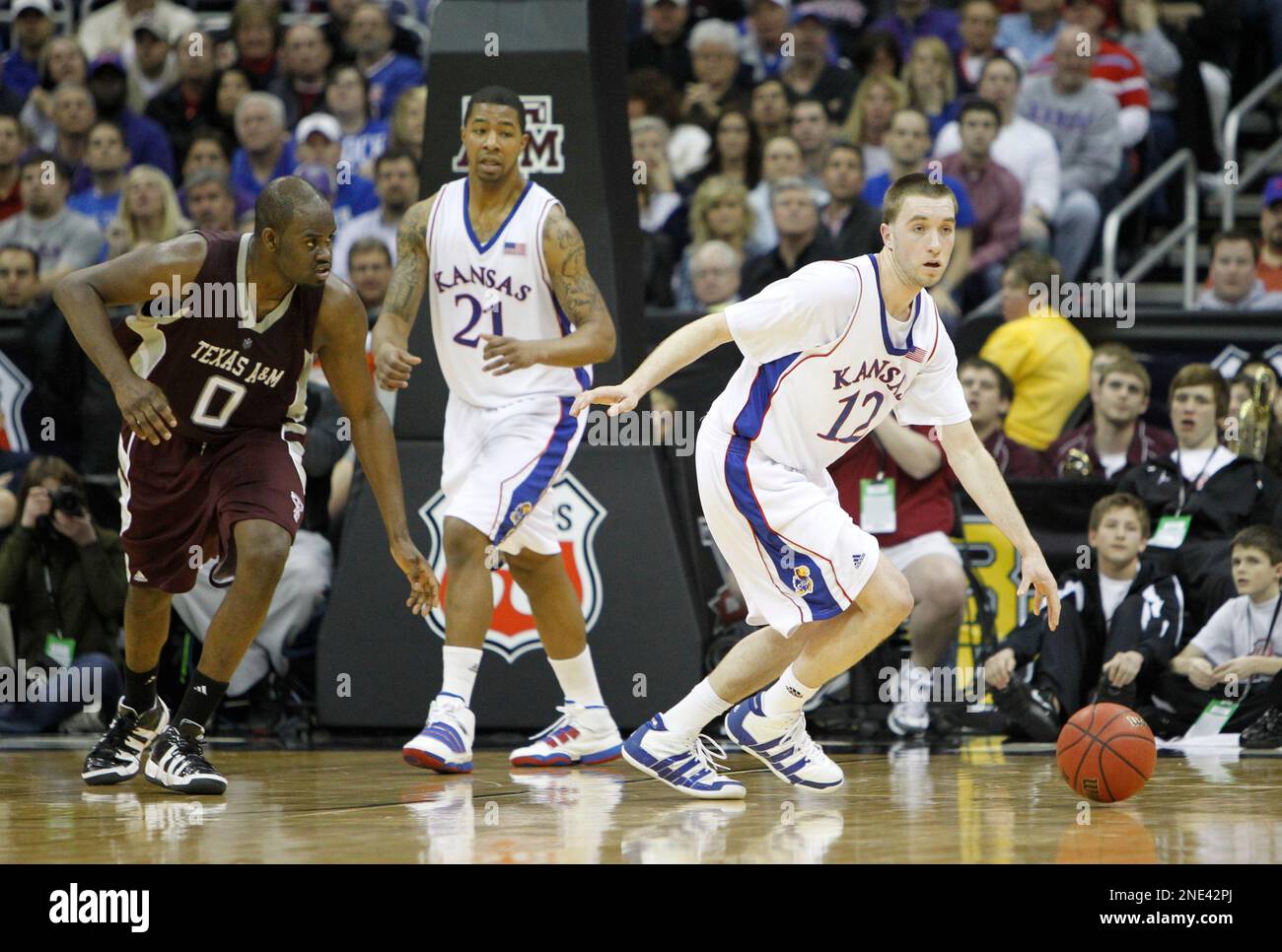 Kansas guard Brady Morningstar, right, dribbles past Texas A&M forward ...
