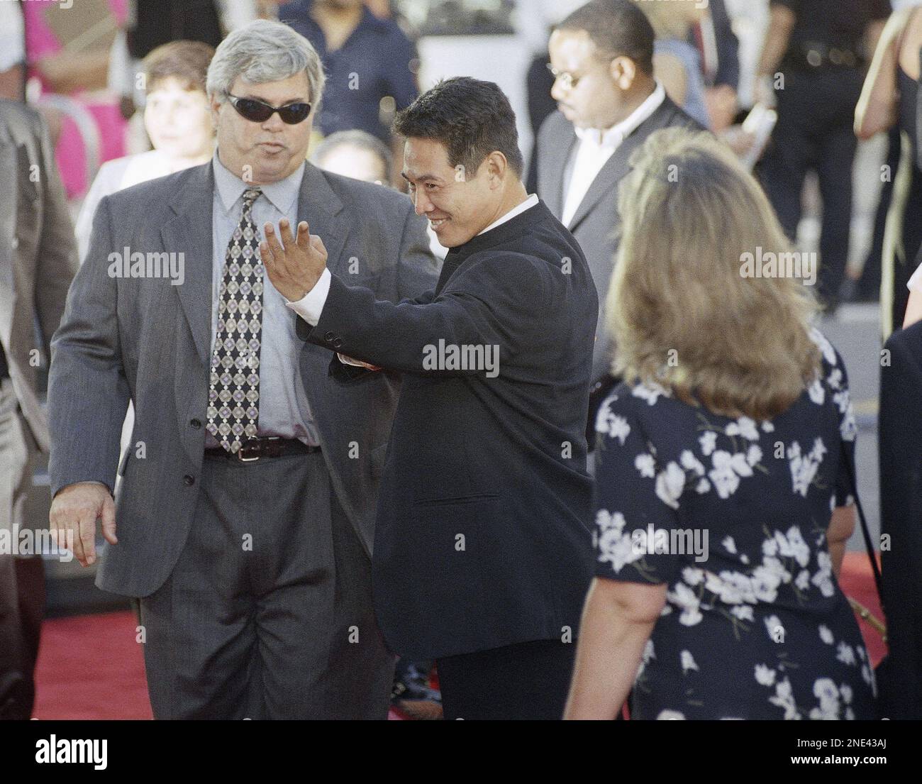 Hong Kong action star Jet Li, waves to fans at the premiere of Warner ...