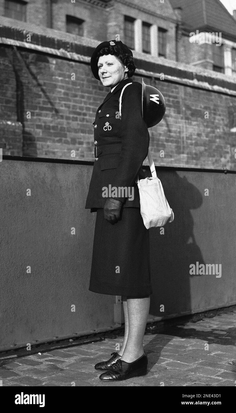 A London Air Raid Warden wears the new uniform of skirt and jacket ...