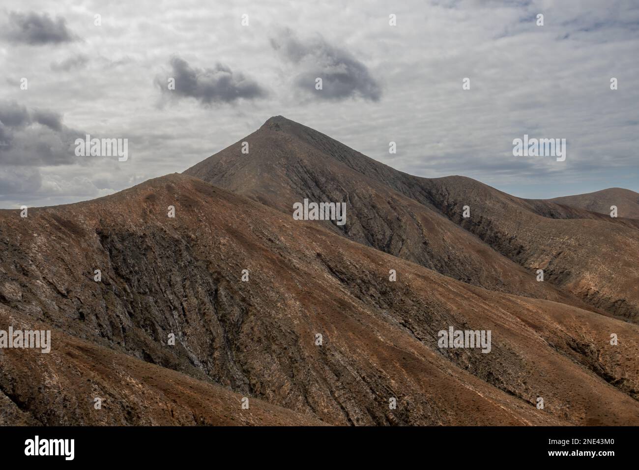 Shapes and lines of the mountains of the volcanic origin. Light brown ...