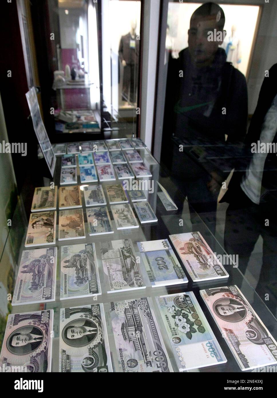 Tourists look at old real ones and replicas of new North Korean ...