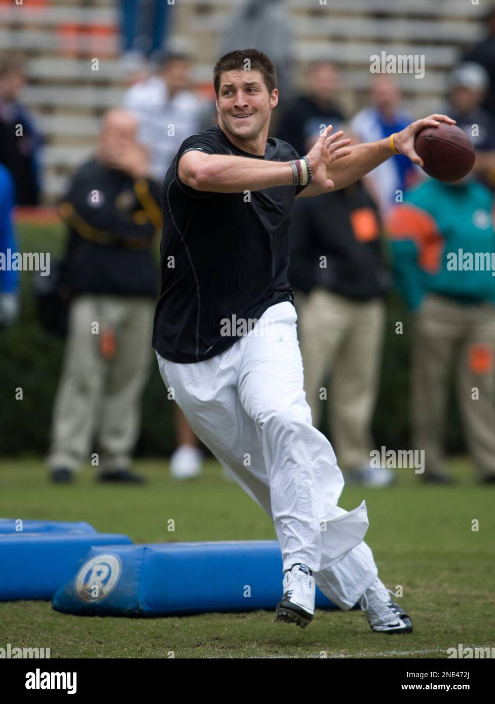 Former Heisman Trophy winning quarterback Tim Tebow throws a pass ...