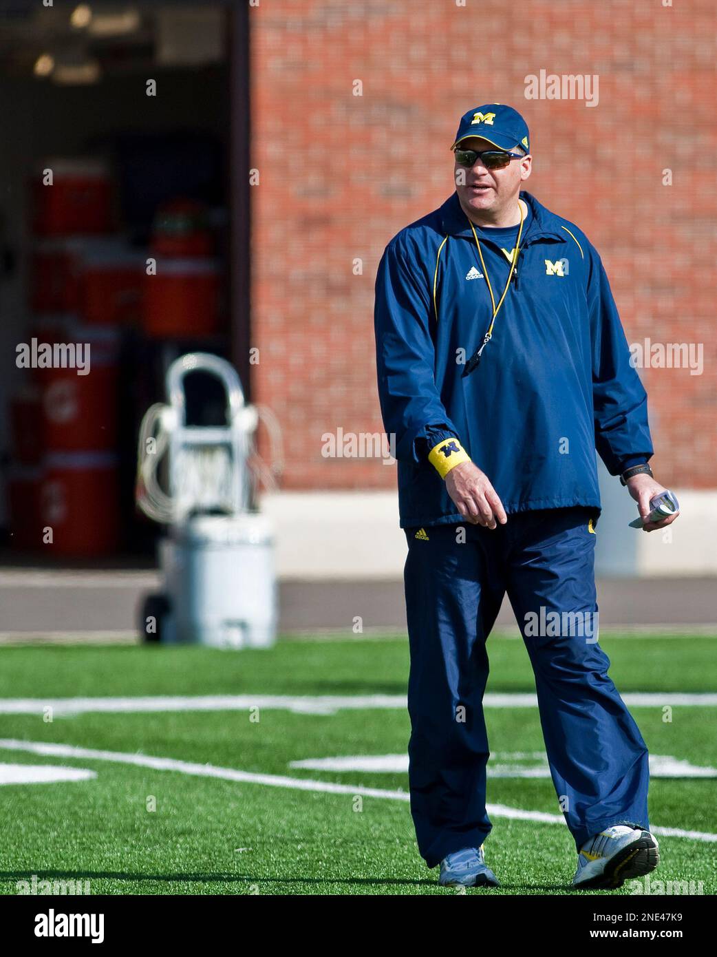 Michigan head coach Rich Rodriguez walks the field watching over his ...
