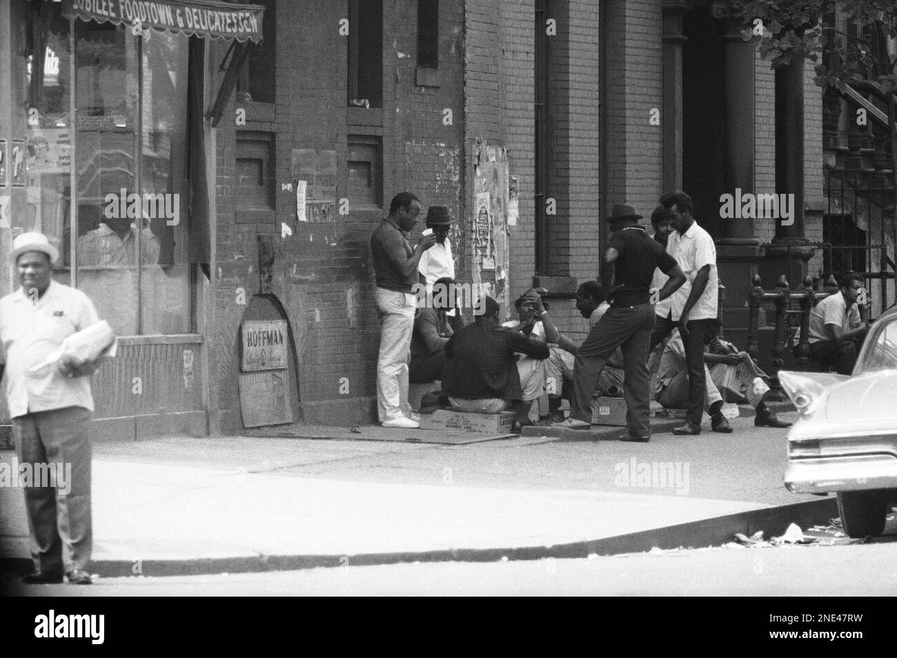 A sidewalk card game is a commonplace sight in New York?s Harlem, shown ...