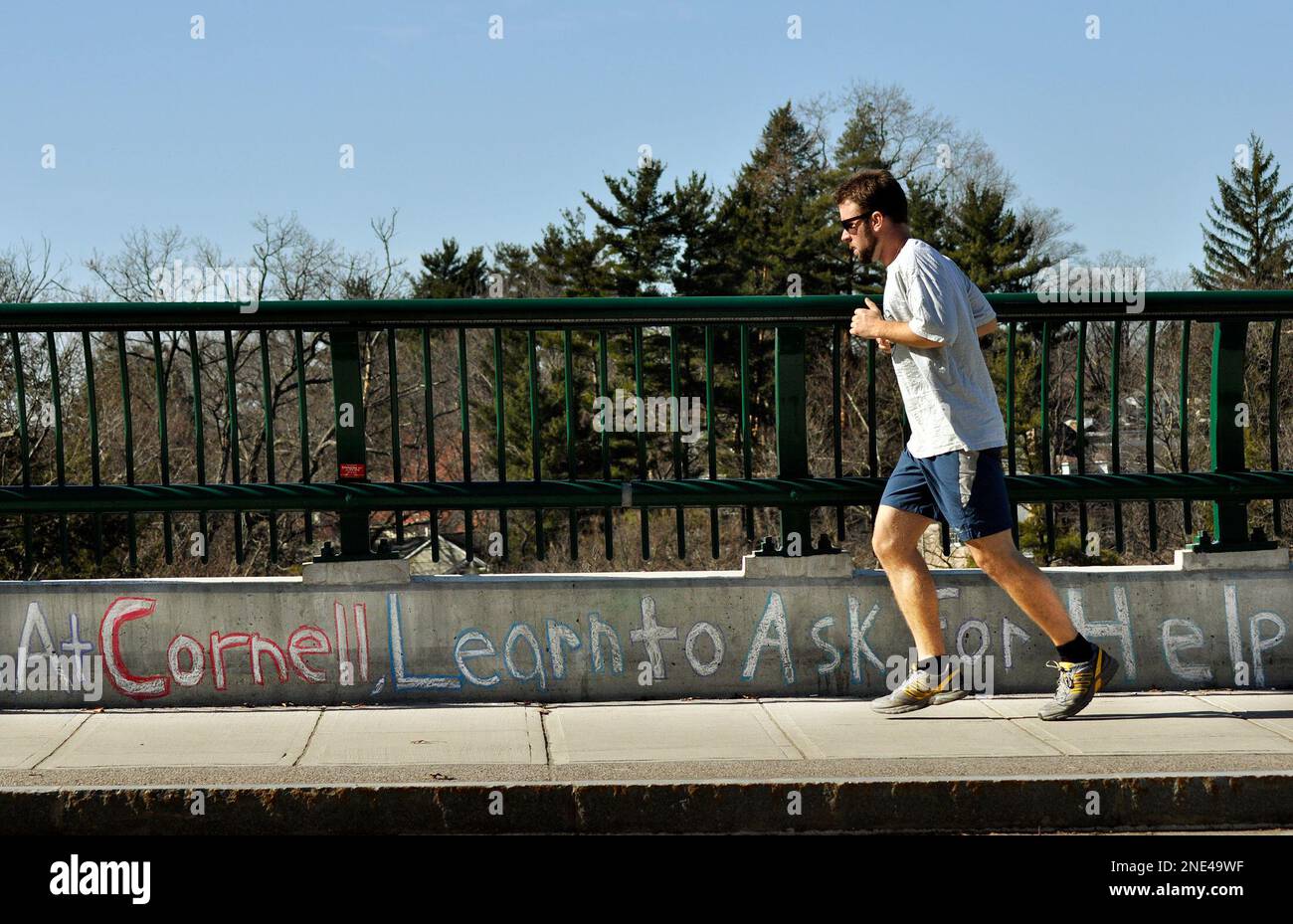 A runner crosses the Thurston Avenue Bridge on the Cornell University ...