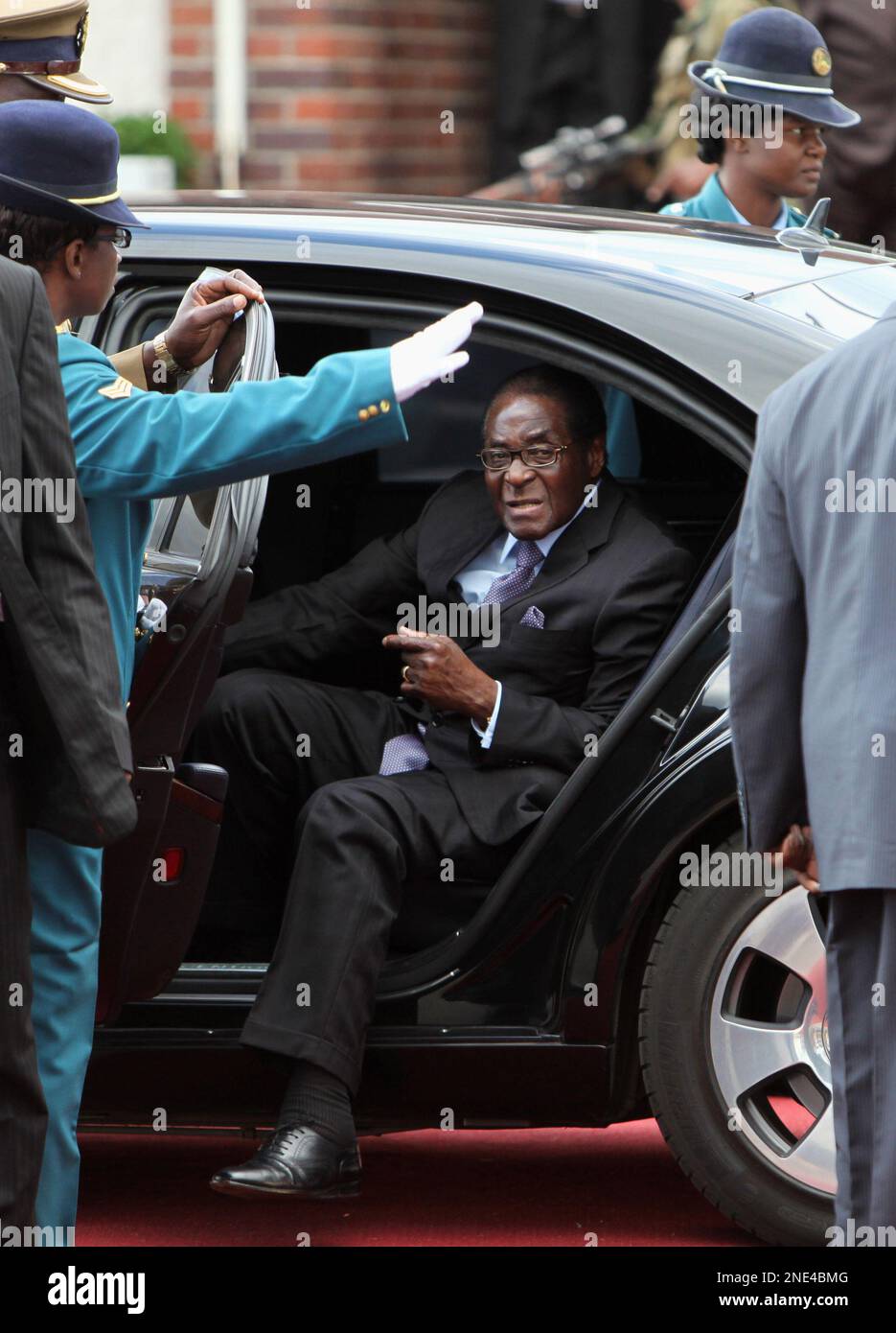 Zimbabwean President Robert Mugabe gets out of his car to meet South ...