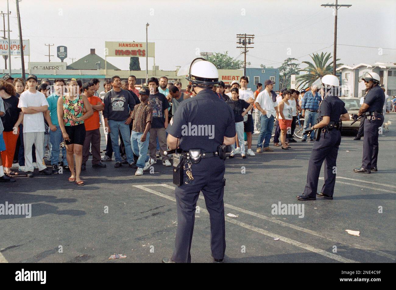 Los Angeles police officers set up a line outside a building in Los ...