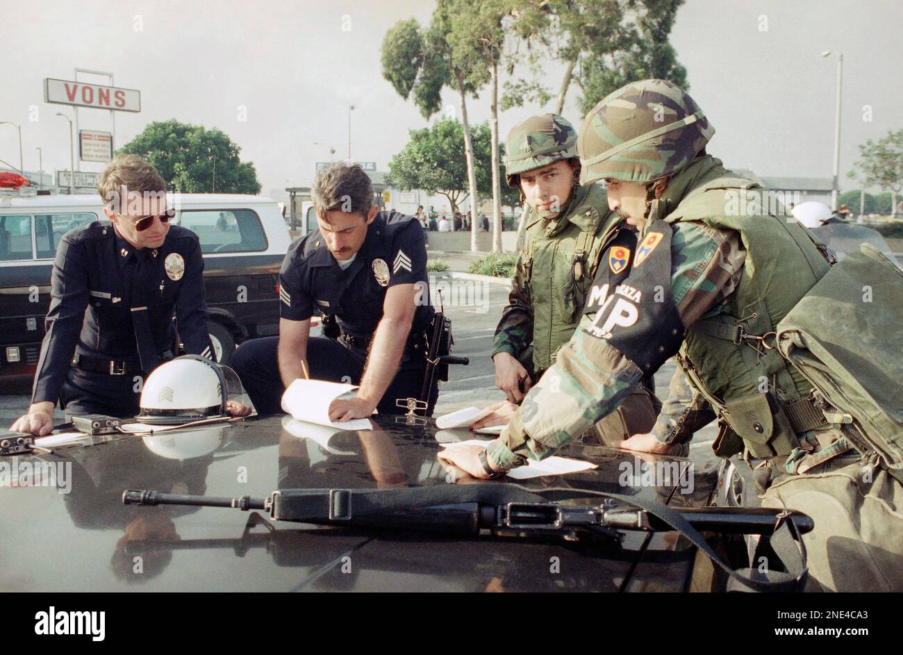 Los Angeles police officers and National Guardsmen review deployments ...