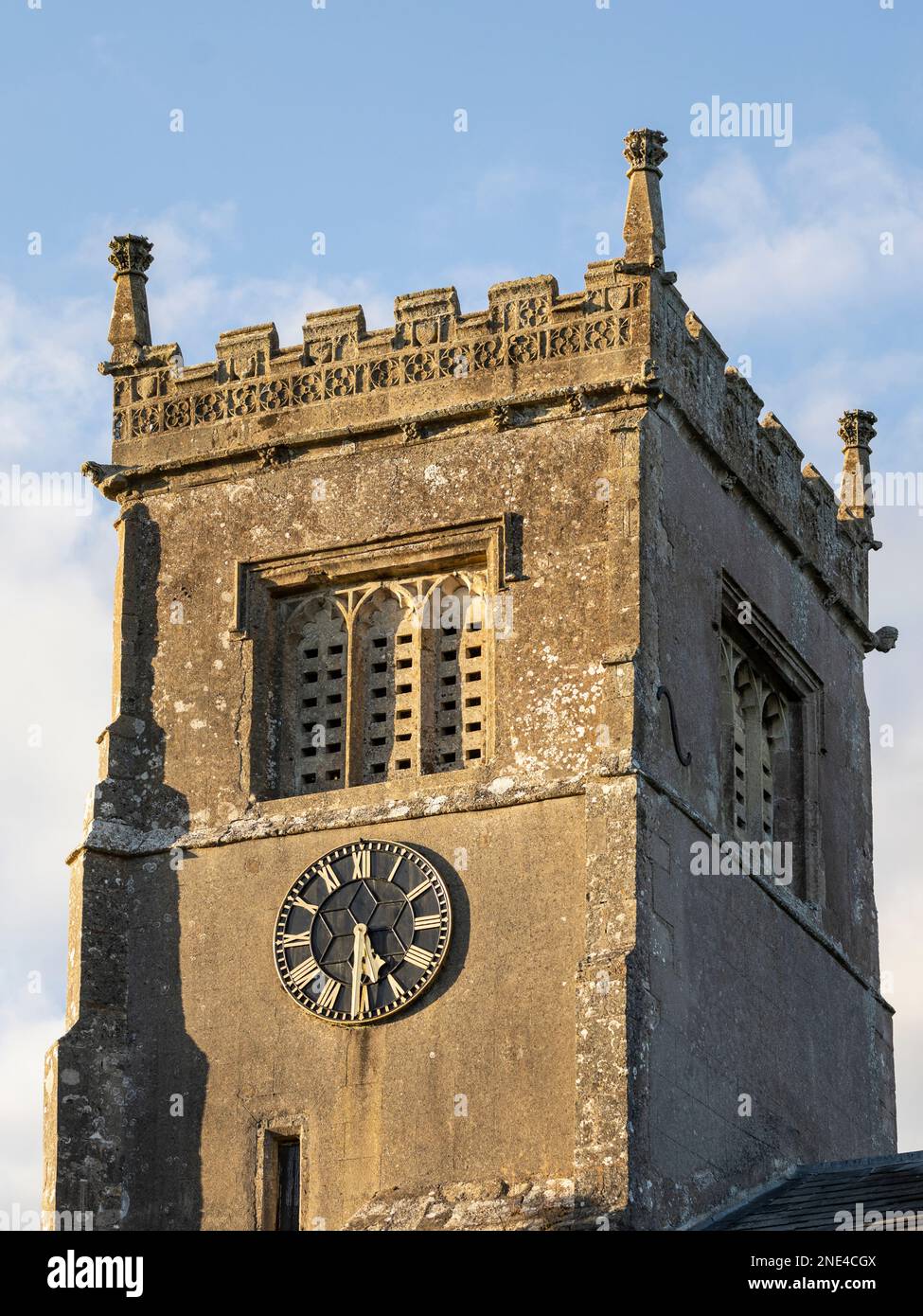 gothic british church tower with clock face in close up Stock Photo - Alamy