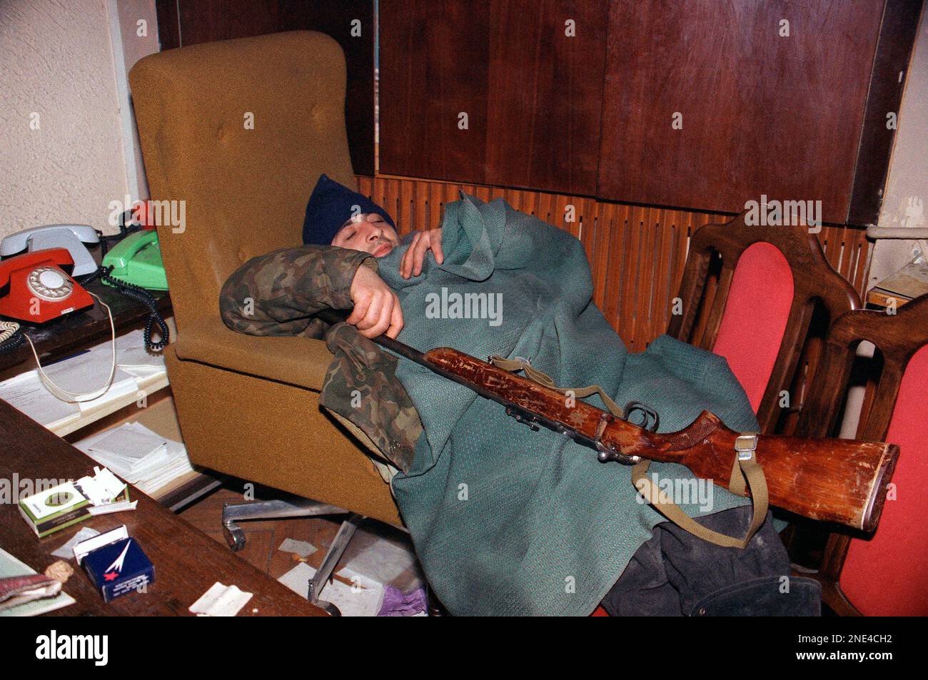 A rebel National Guardsman takes a break from fighting troops loyal to ...