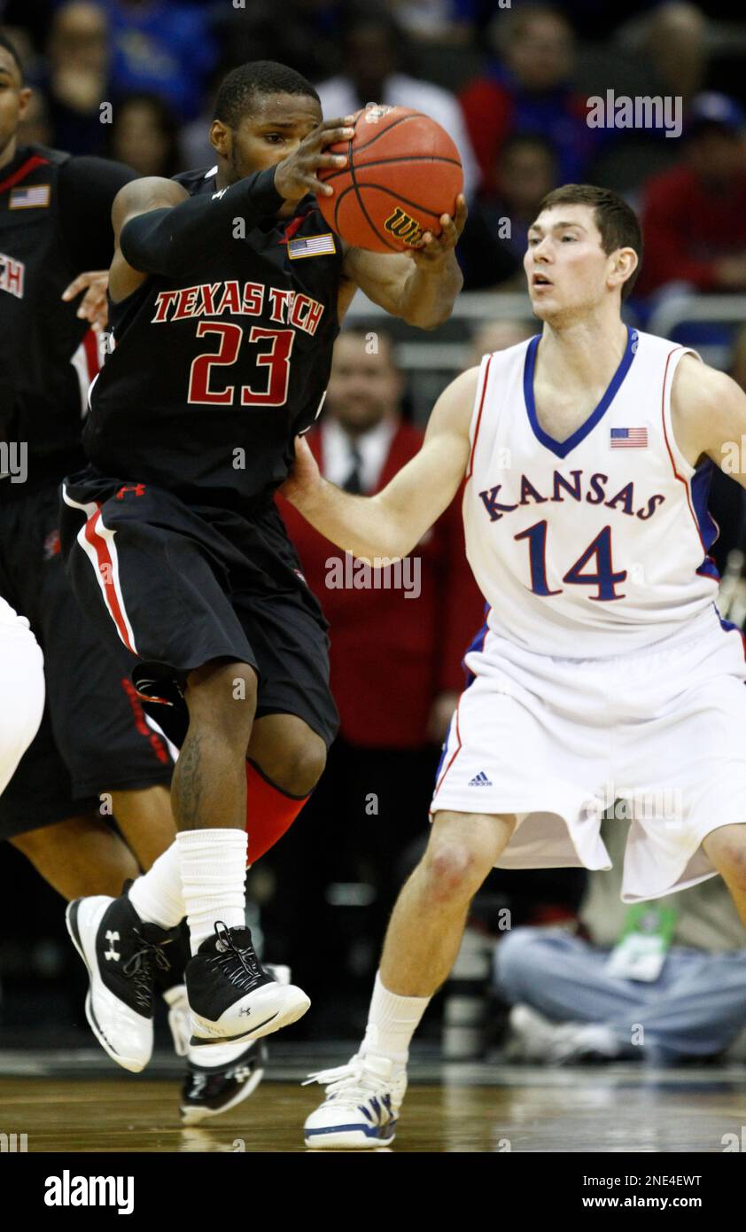 Texas Tech guard Nick Okorie, left, drives past Kansas guard Tyrel Reed ...