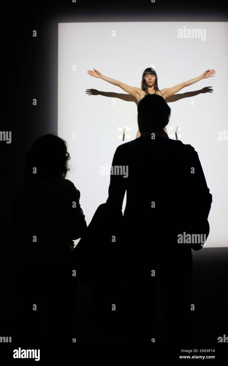 Visitors to the Museum of Modern Art watch a woman performing ...