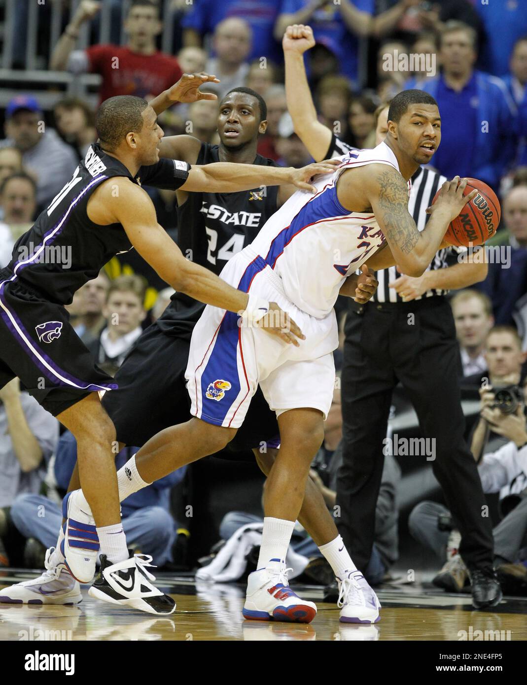 Kansas forward Markieff Morris, right, is fouled by Kansas State guard ...