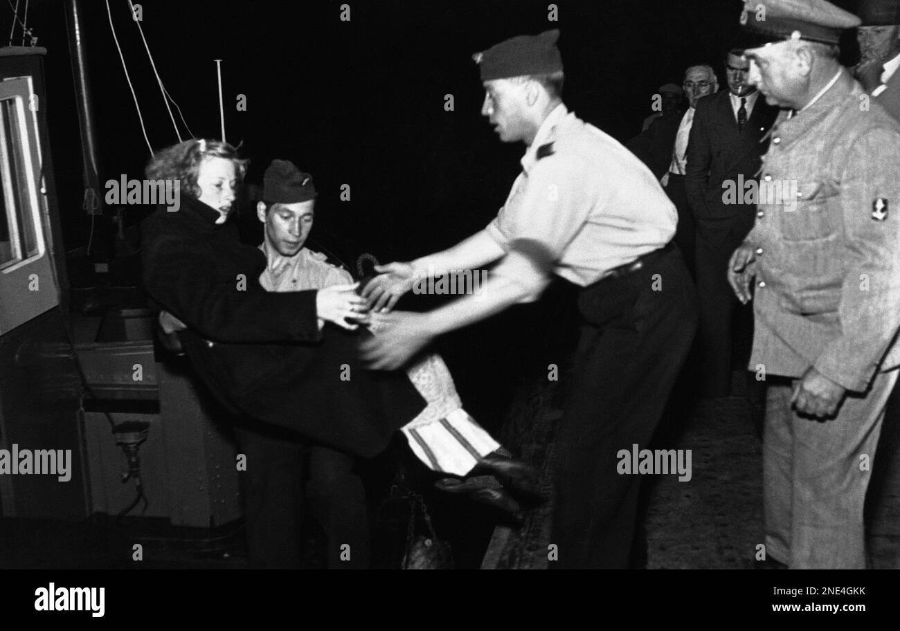 The Portuguese sloop Pedro Nunes offloads some of the survivors of the ...