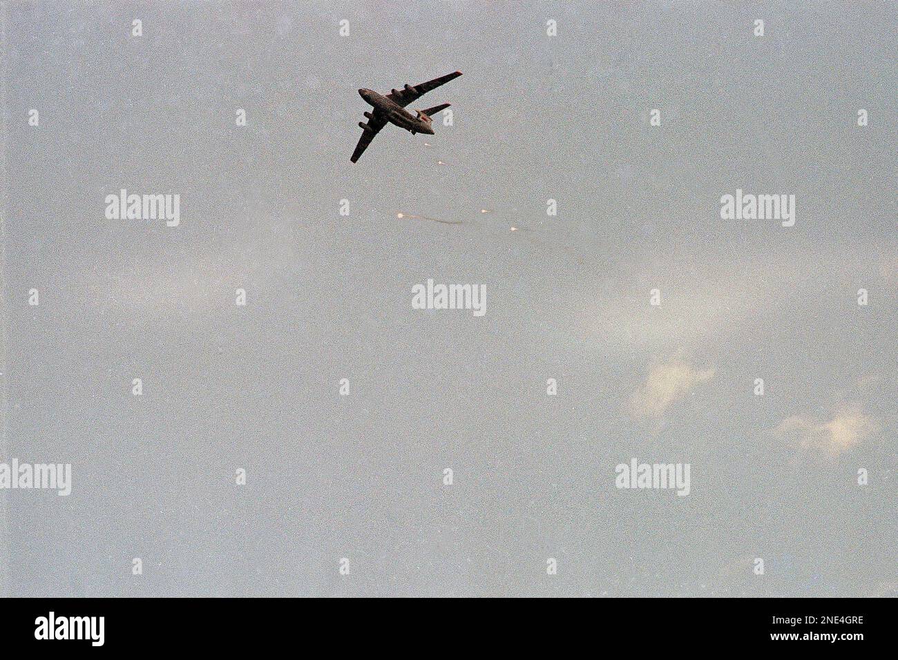 A Soviet II-76 cargo-jet spits magnesium flares into the air, after ...