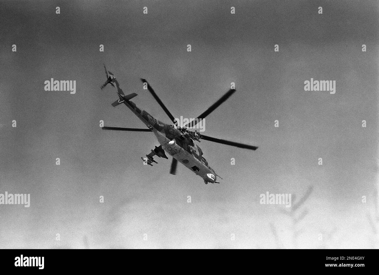 A Soviet-built helicopter of the Afghan Air Force flies over the Afghan ...