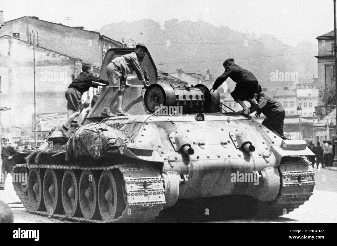 An abandoned tank, left by retreating Soviet troops, becomes a toy for ...