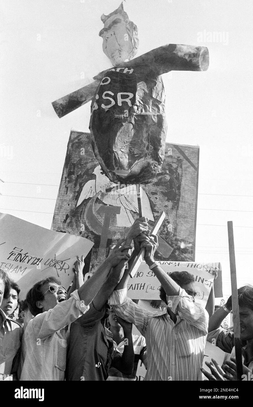 Thai Muslim demonstrators carry placards denouncing Soviet intervention ...