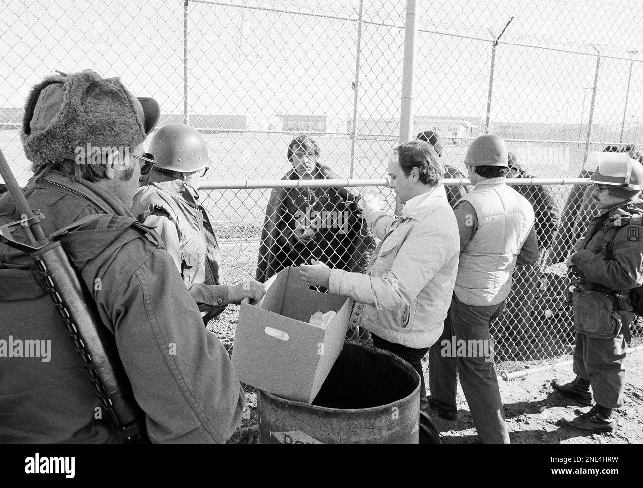 Members of the New Mexico National Guard pass oranges and sandwiches to ...