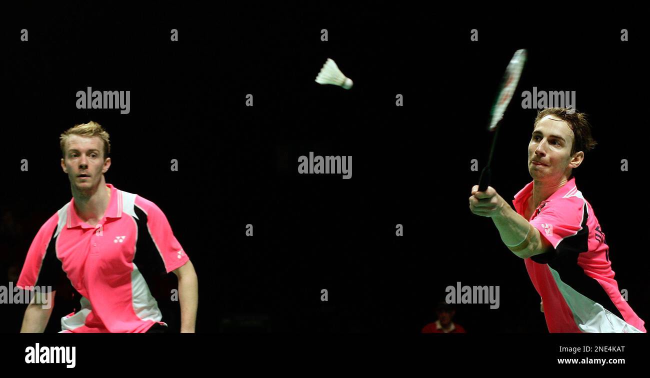 Denmark's Mathias Boe, right, hits a shot as his partner Carsten ...