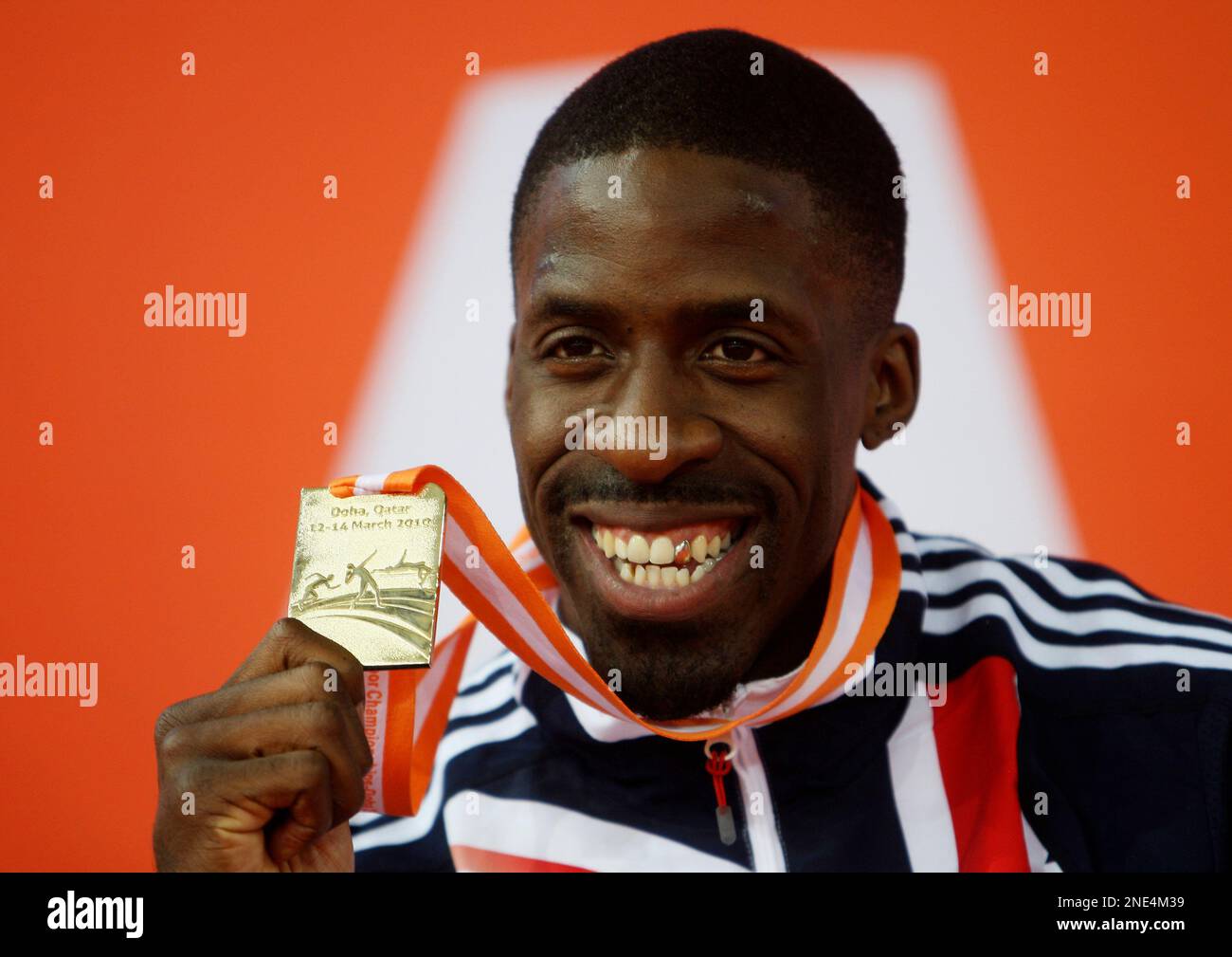 Britain's Dwain Chambers shows off his gold medal during the ceremony ...