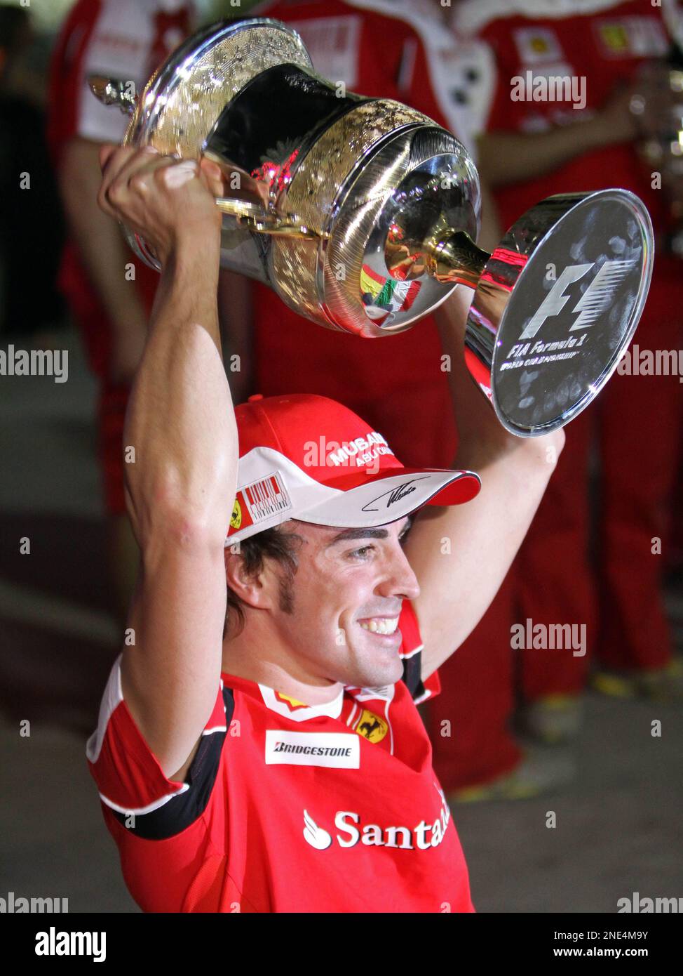 Ferrari driver Fernando Alonso of Spain poses for photographs with his ...