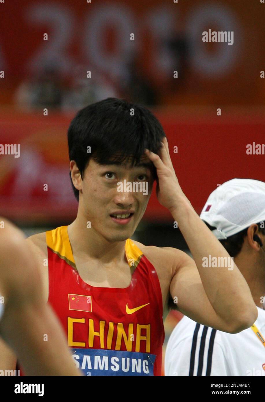 China's Liu Xiang reacts after placing 7th in the final of the Men's ...