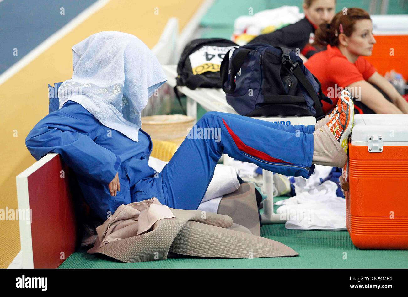 Russia's Yelena Isinbayeva sits with a towell over her head in between ...