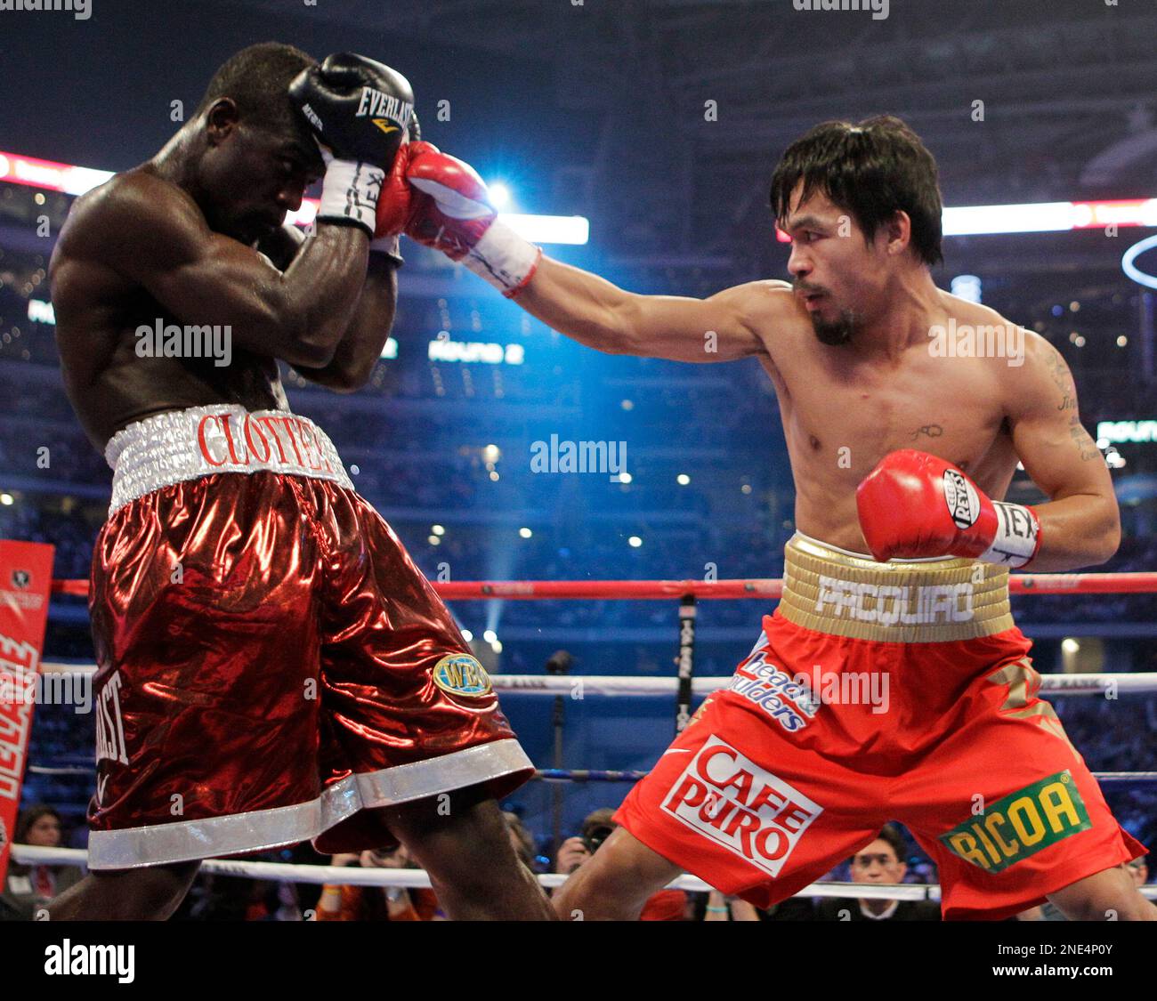 Joshua Clottey, from Ghana, protects himself from Manny Pacquiao, right ...