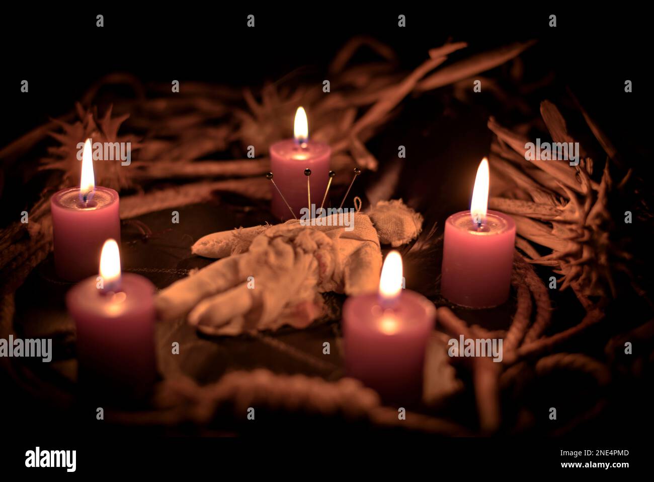 Occultist dripping hot wax on voodoo doll, magic rituals, black spell ...