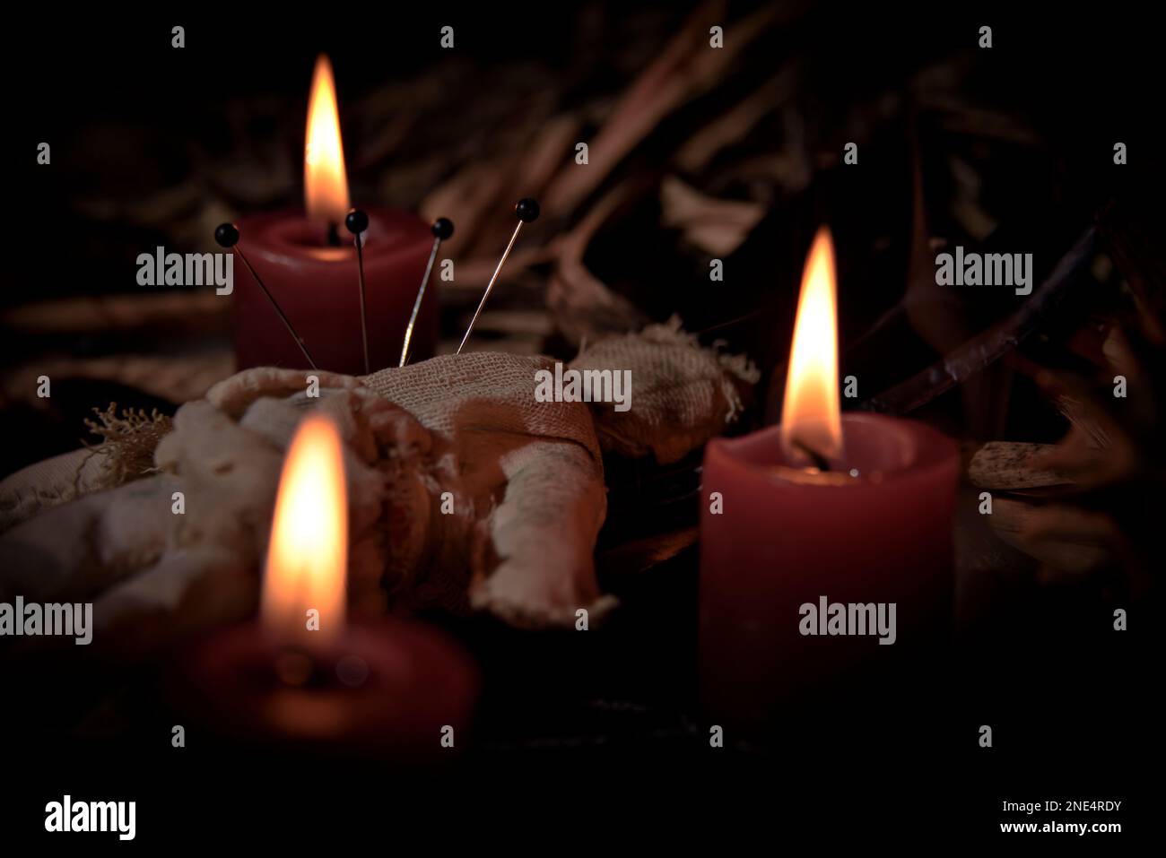 Occultist dripping hot wax on voodoo doll, magic rituals, black spell ...