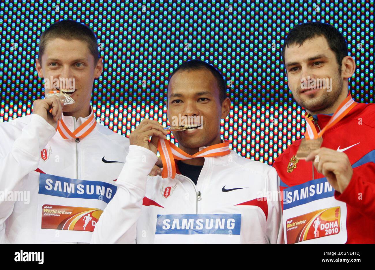 United States' gold medalist Bryan Clay is flanked by United States ...