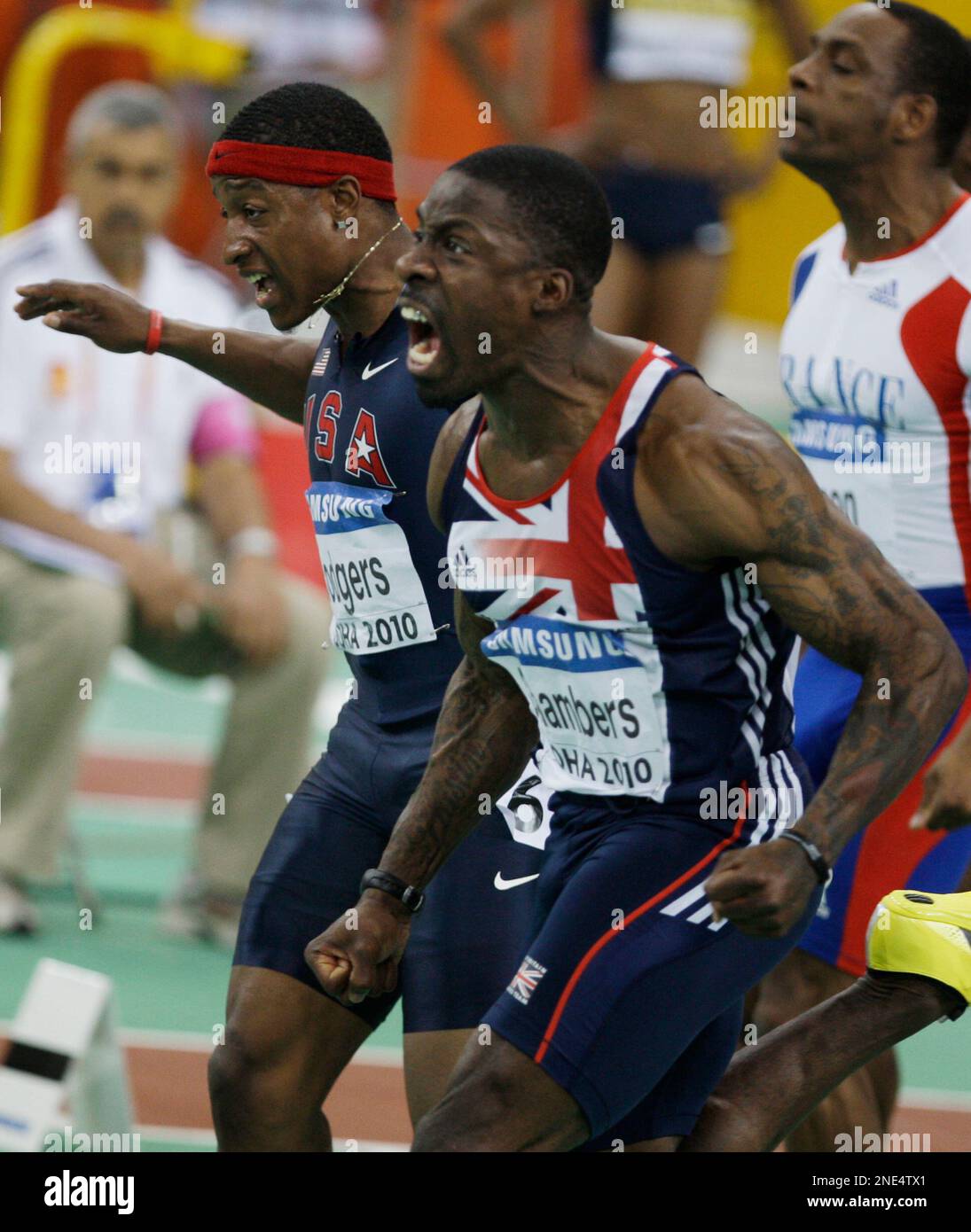 Britain's gold medal winner Dwain Chambers, front, shouts as he crosses ...