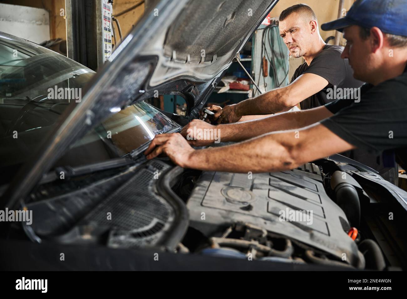 Repairmen, workers, mechanics opening repairing car engine ...
