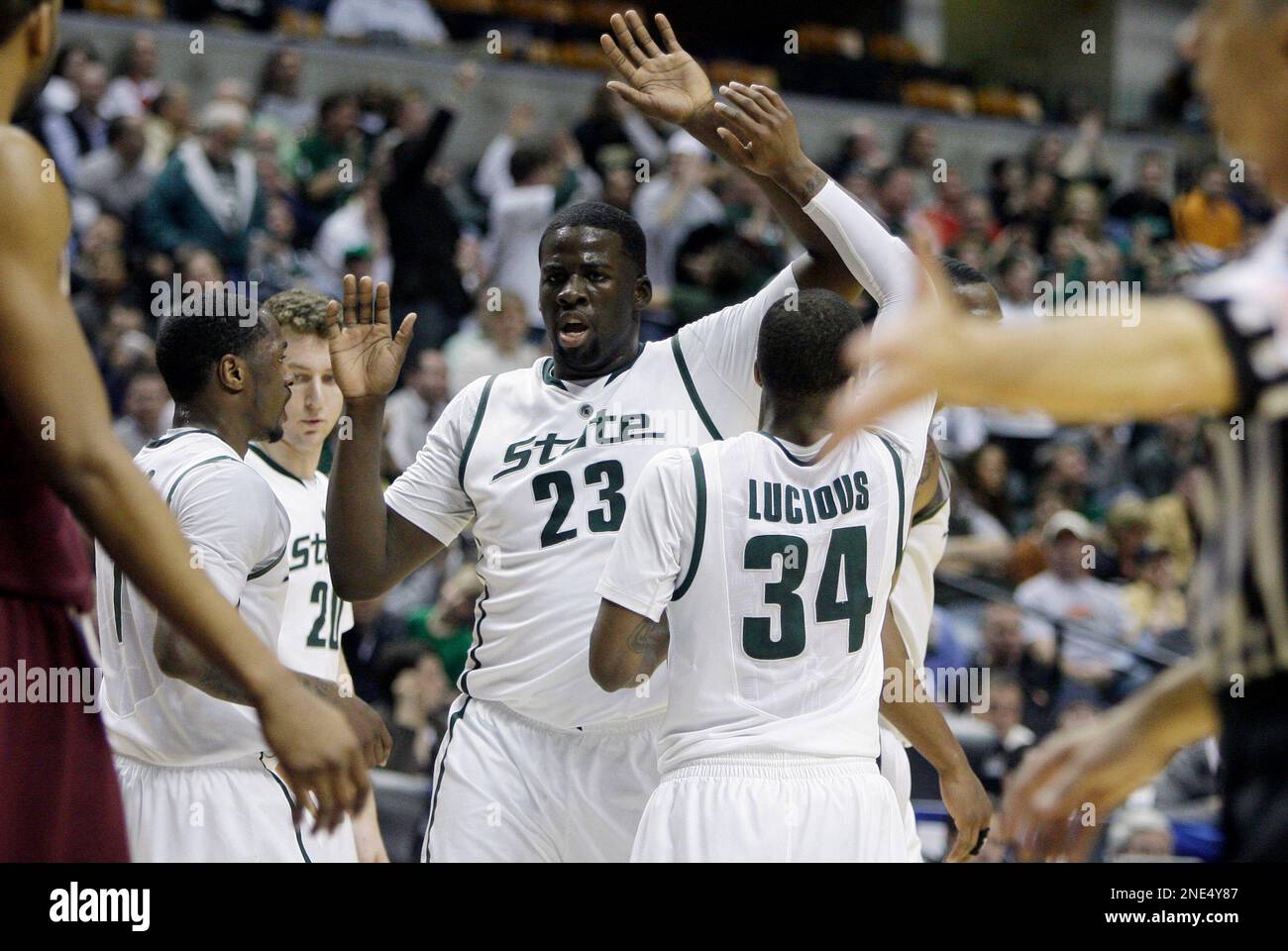 Michigan State's Draymond Green (23) gives high-fives after being ...