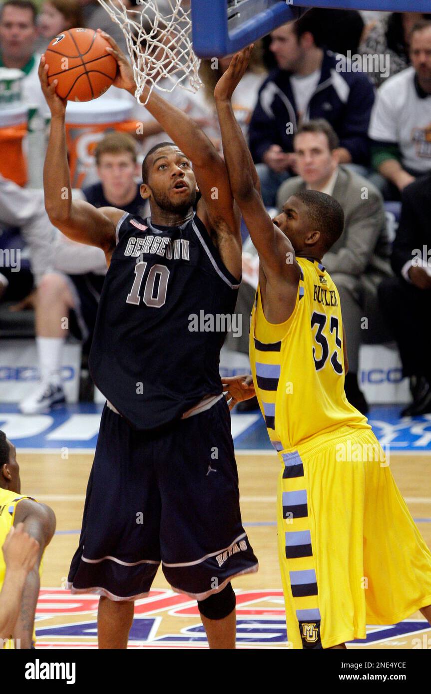 Georgetown's Greg Monroe (10) shoots over Marquette's Jimmy Butler (33 ...