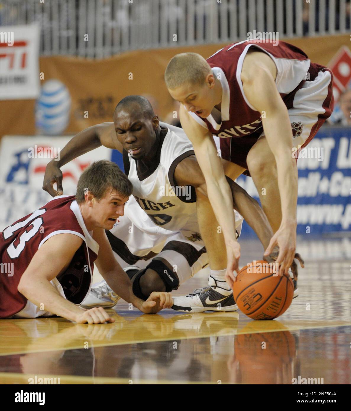 Lehigh forward Zahir Carrington, center, scrambles for a loose ball ...