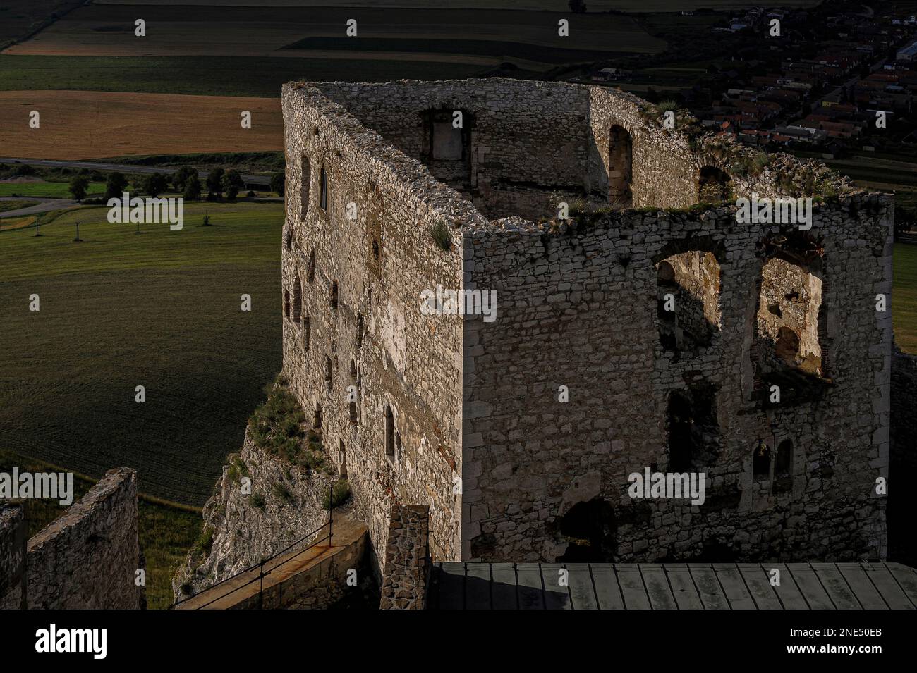 Evening sunshine on the ruined rubble walls of a three-storey ...