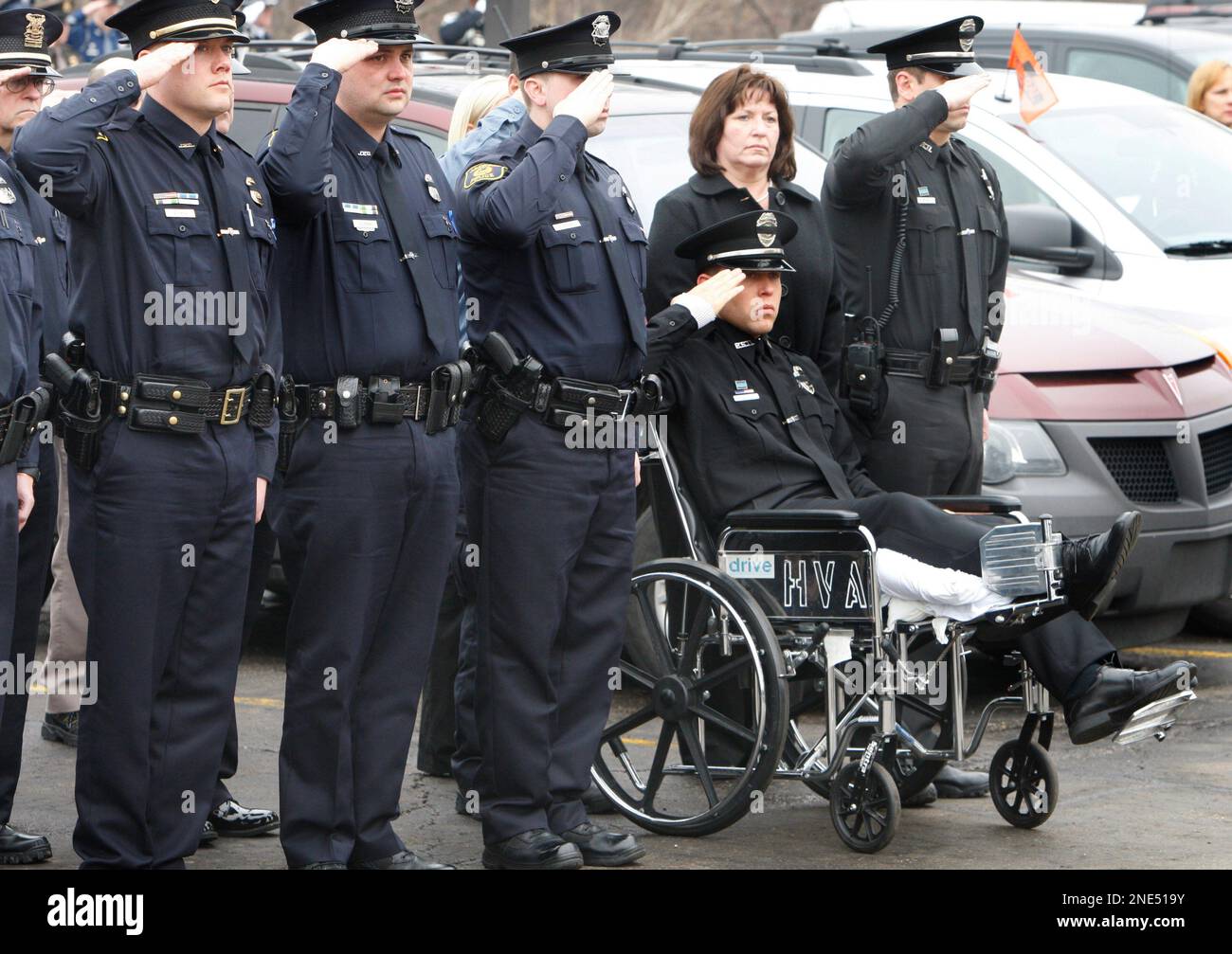 Members of the Jackson, Mich., police department salute the casket of ...