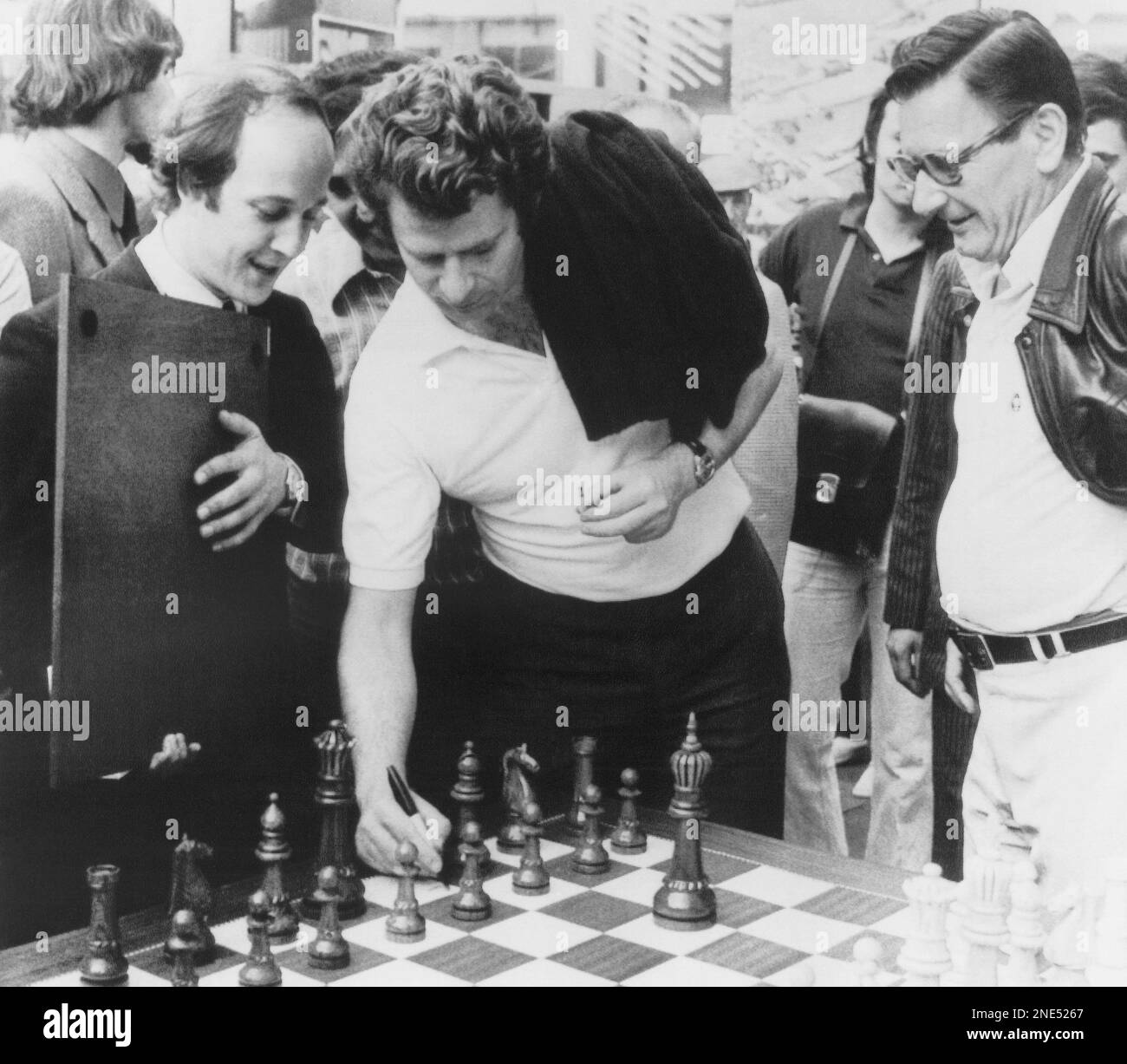 Soviet chess player Boris Spassky signs a huge chessboard located in ...