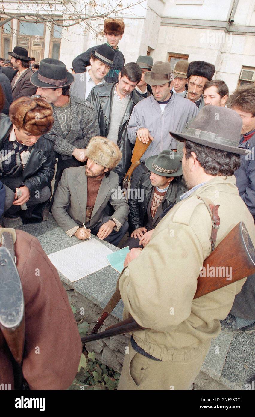 Local Chechen men, some carrying rifles, sign up for the Chechen-Ingush ...