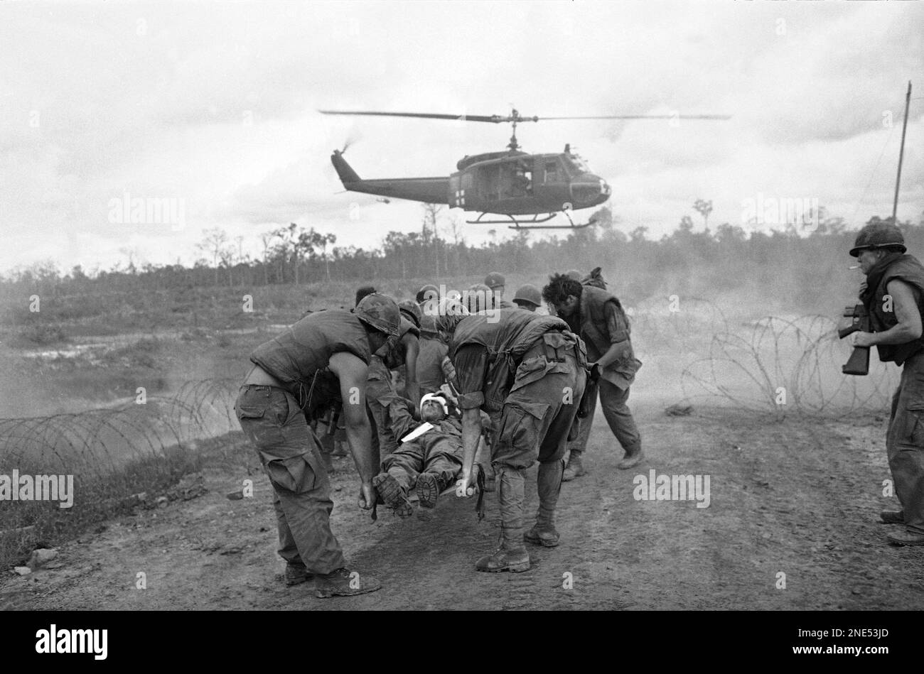 American and South Vietnamese troopers break into a run as they carry ...