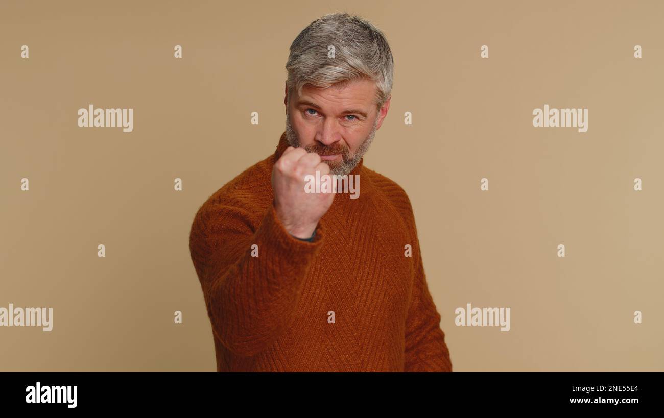 Aggressive angry middle-aged man trying to fight at camera, shaking ...
