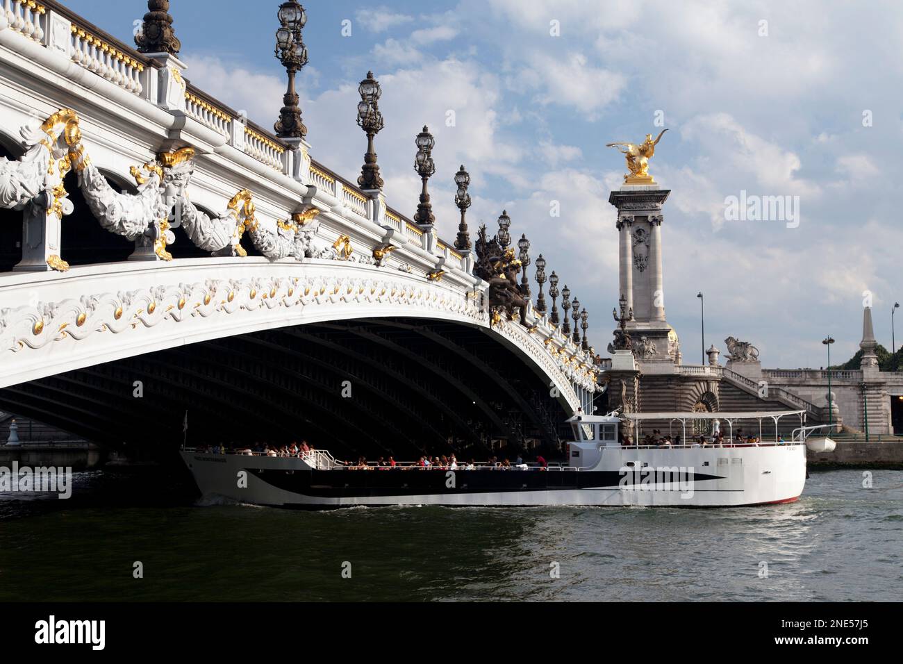 France, Paris, tourist boat passing under the Pont Alexander III bridge ...
