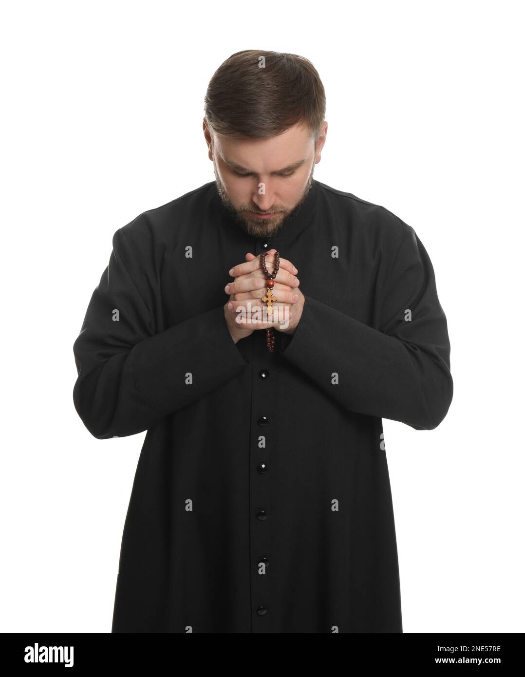 Priest with rosary beads praying on white background Stock Photo - Alamy