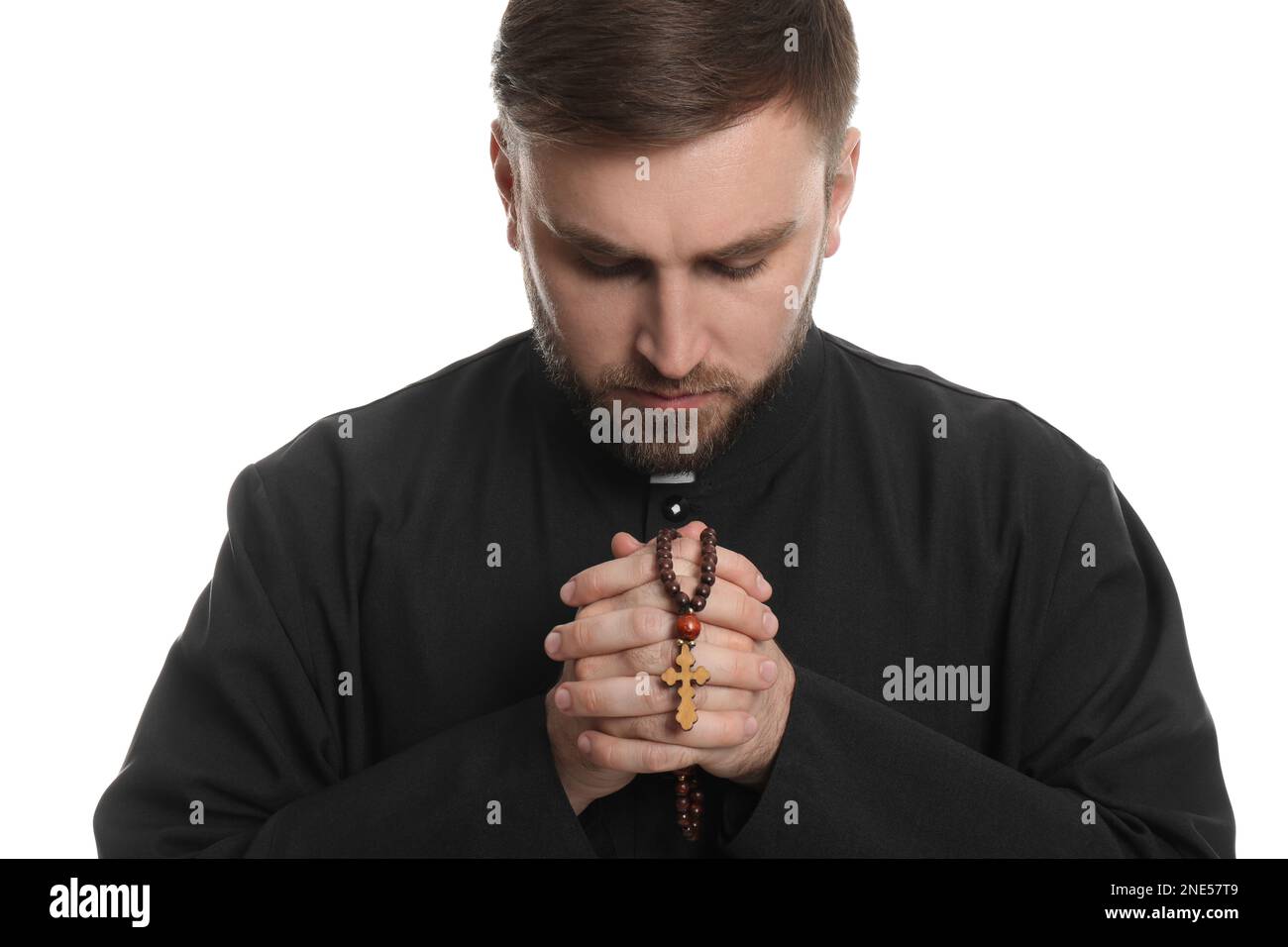 Priest with rosary beads praying on white background Stock Photo - Alamy