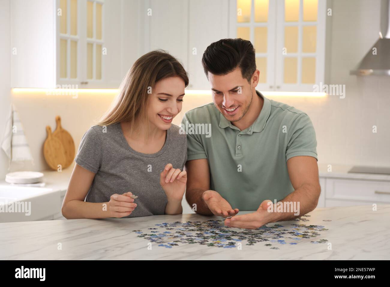 Happy woman playing puzzles hi-res stock photography and images - Alamy