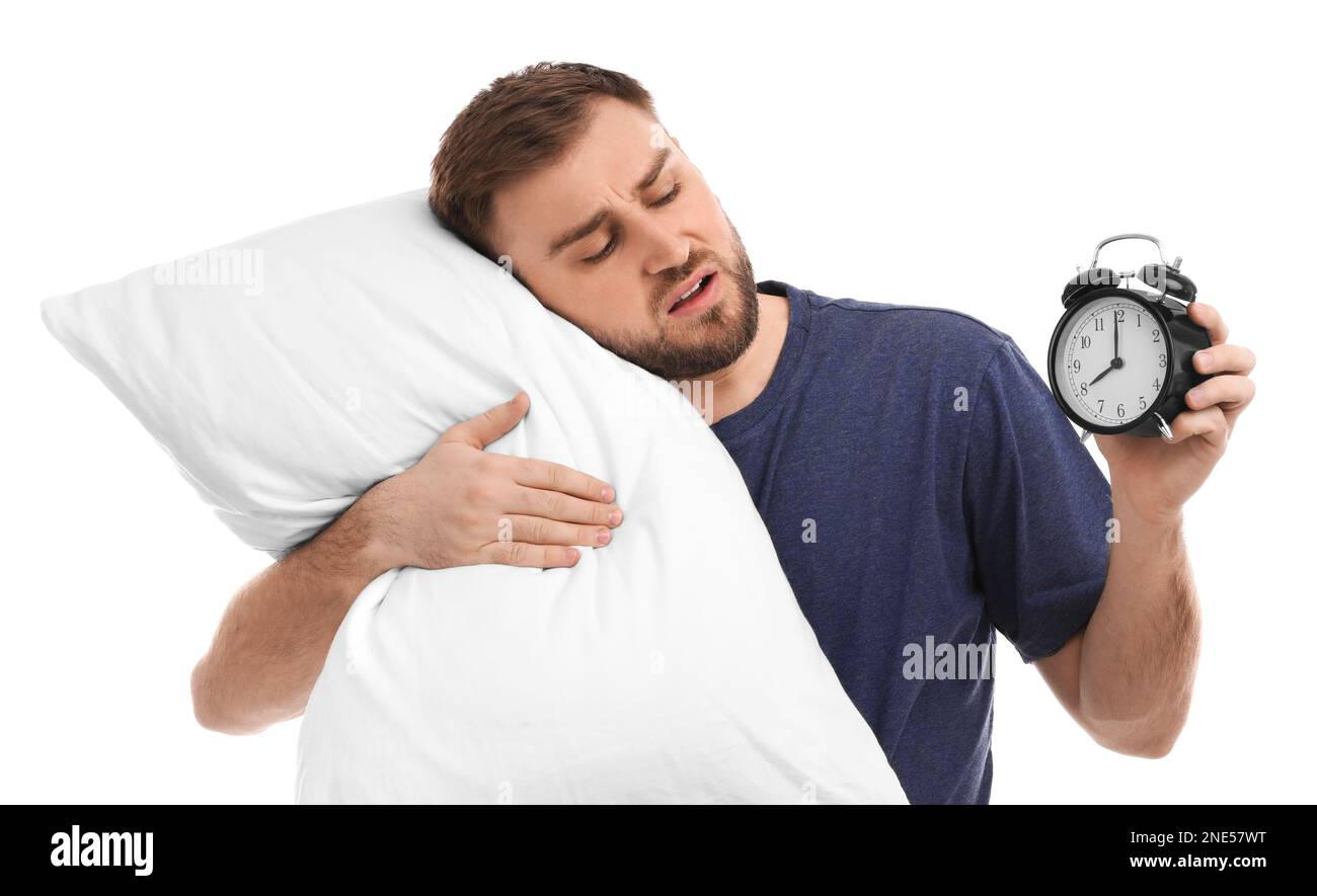 Sleeping man with alarm clock and pillow on white background. Being ...