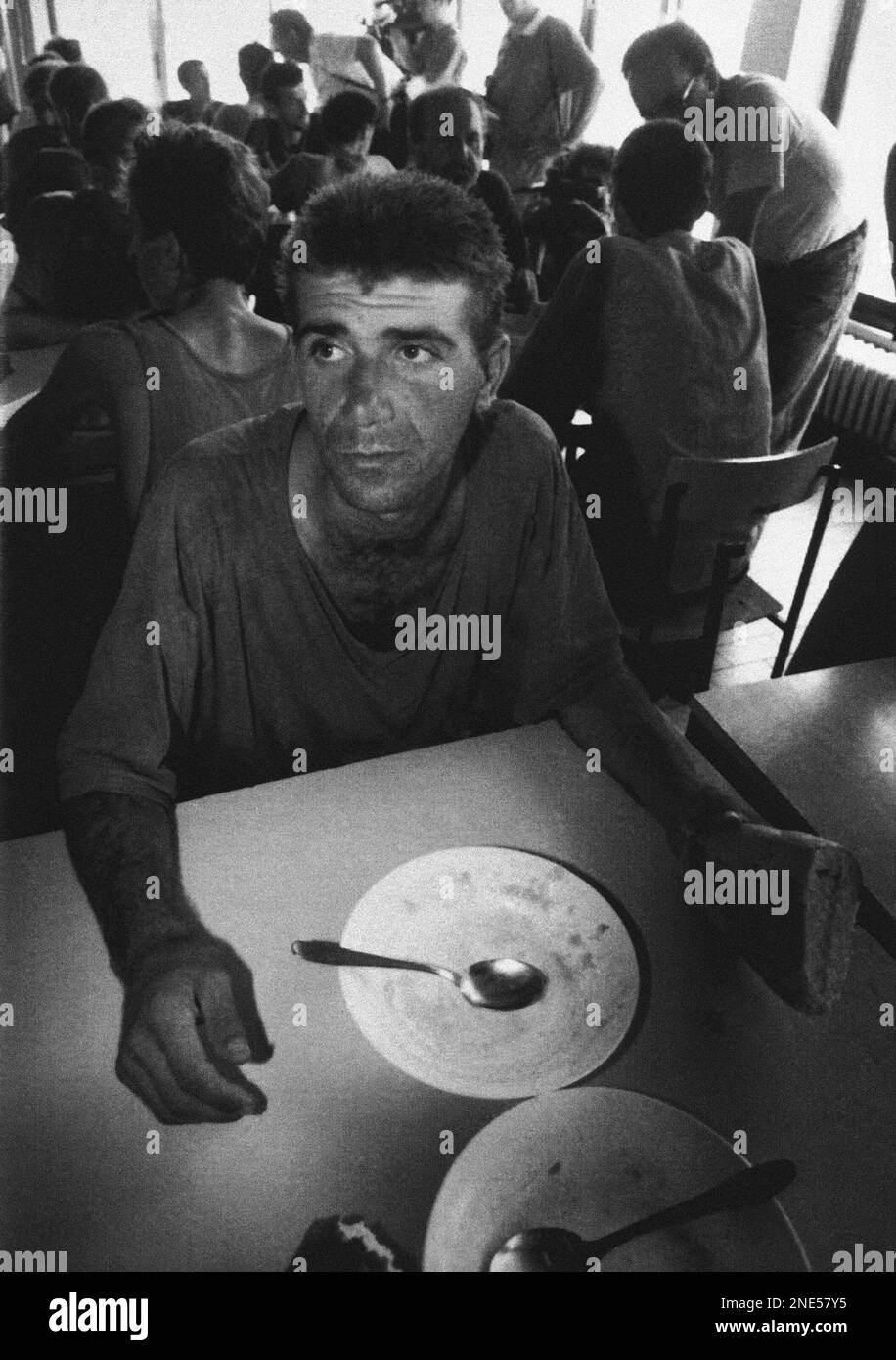 An unidentified Muslim prisoner holds a piece of bread after finishing ...