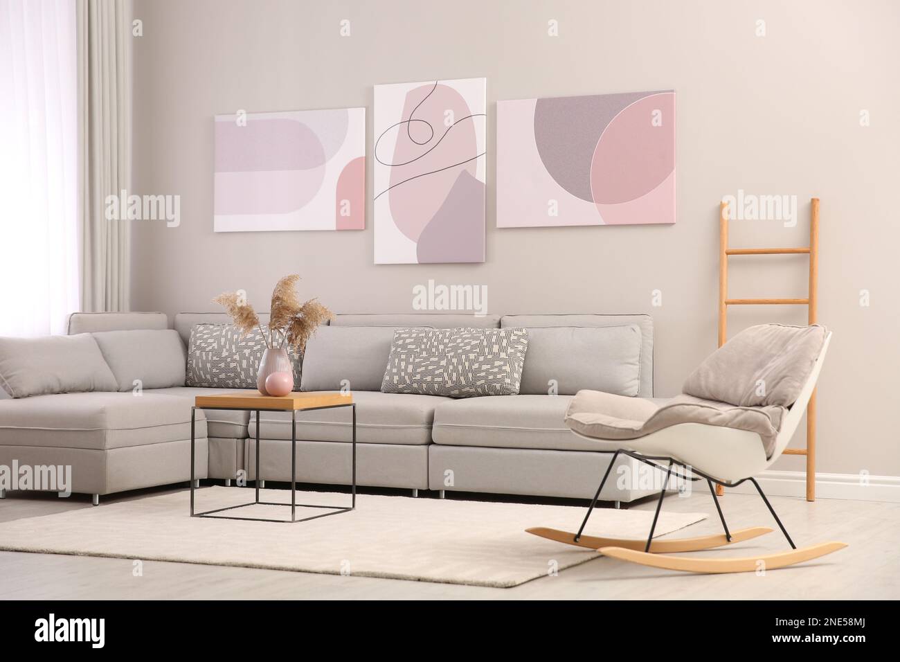 Stylish living room interior with big comfortable sofa and pictures ...